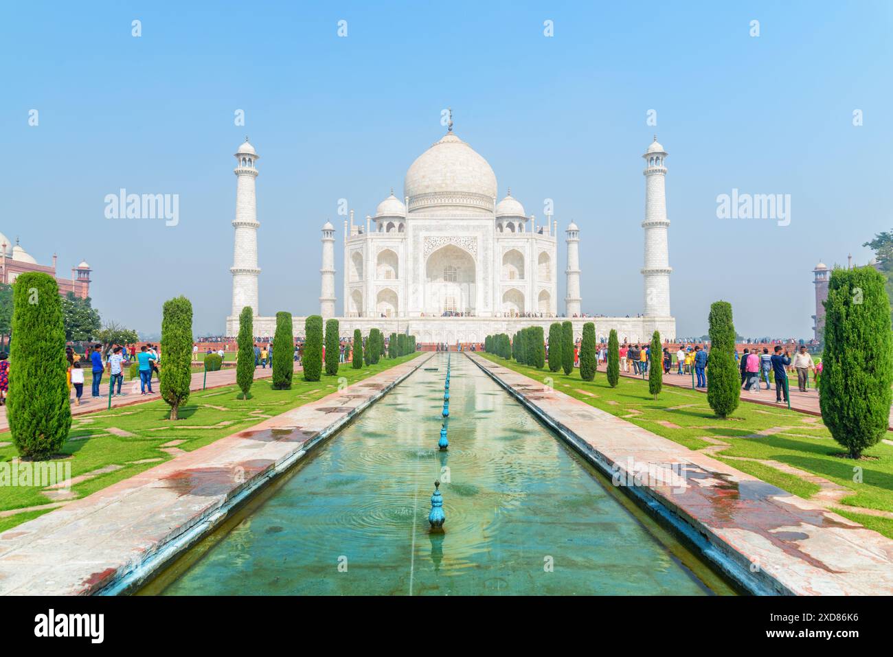 Colorful crowds of visitors walking along the Taj Mahal complex in Agra ...