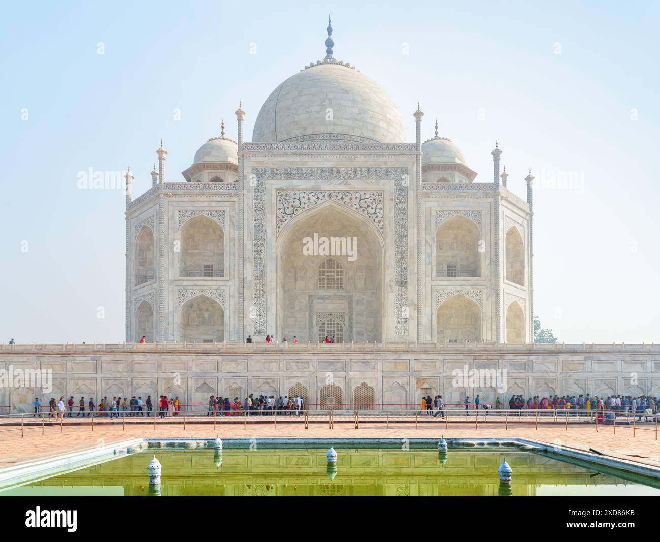 Colorful crowds of visitors walking along the Taj Mahal complex in Agra ...