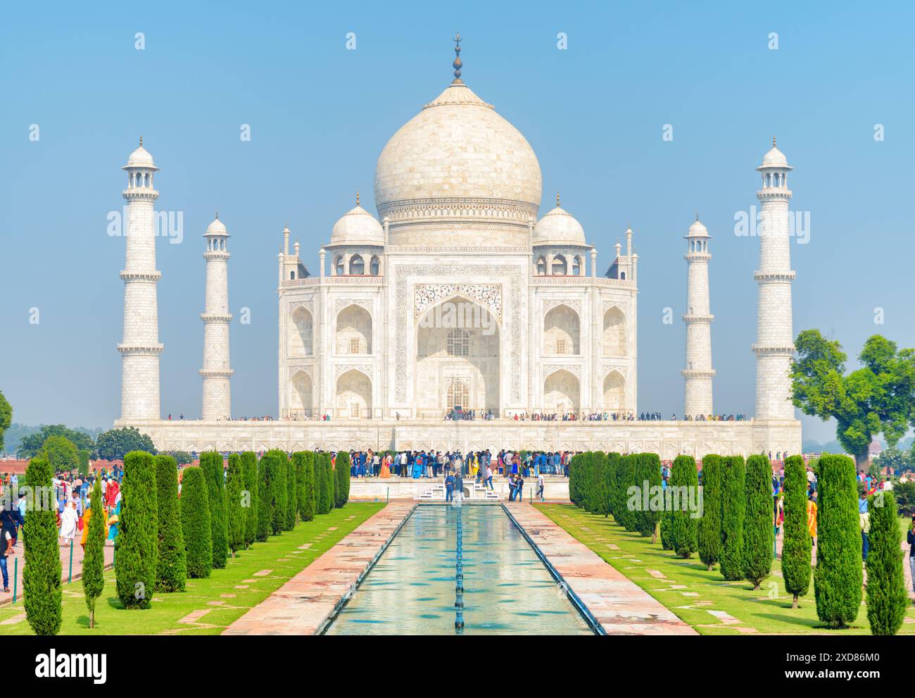 Colorful crowds of visitors walking along the Taj Mahal complex in Agra ...