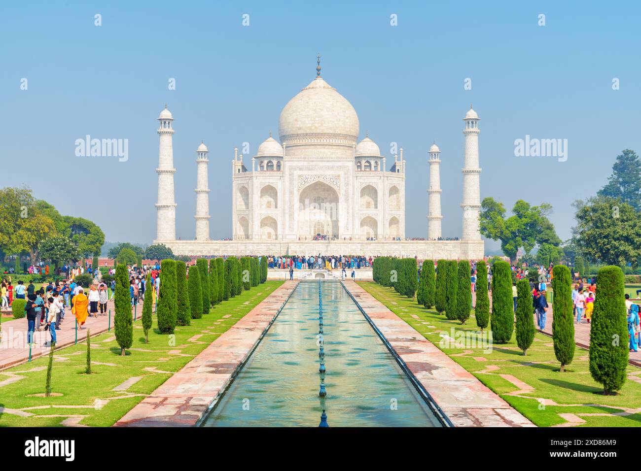 Colorful crowds of visitors walking along the Taj Mahal complex in Agra ...