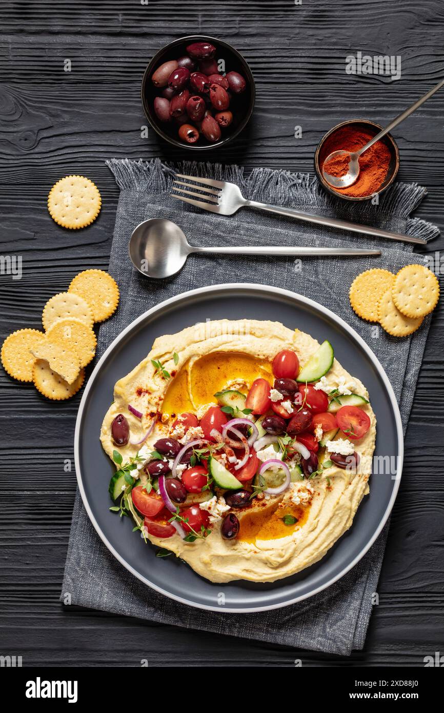 Greek hummus loaded with fresh cucumbers, olives, tomatoes, feta cheese ...