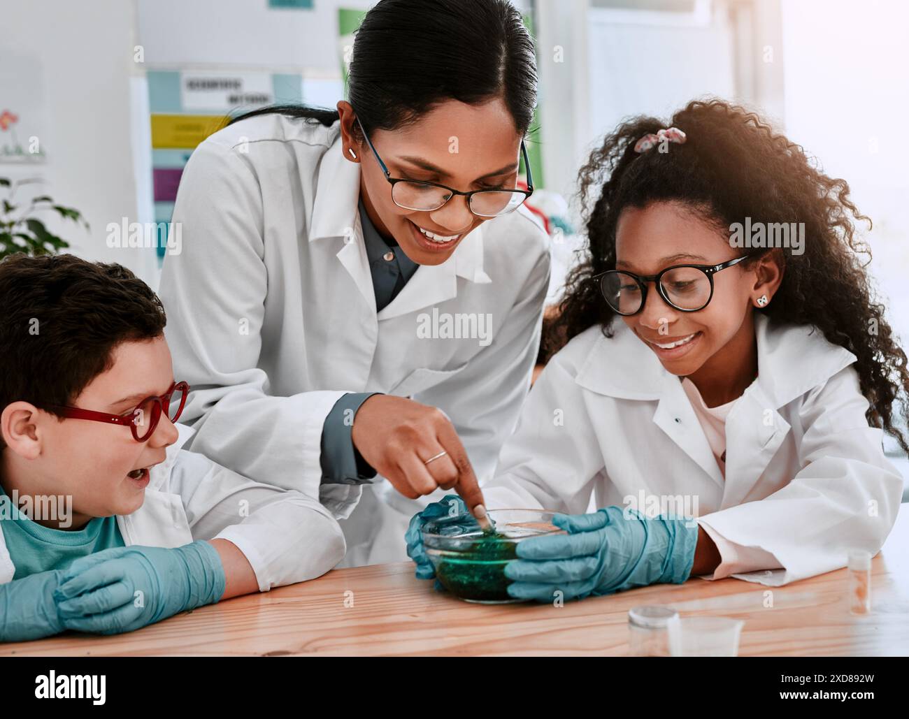 Science, teacher and students in classroom with experiment, support and ...