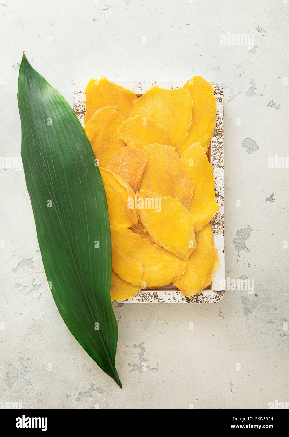 Slices of large sweet dried mangoes in wooden box Stock Photo - Alamy