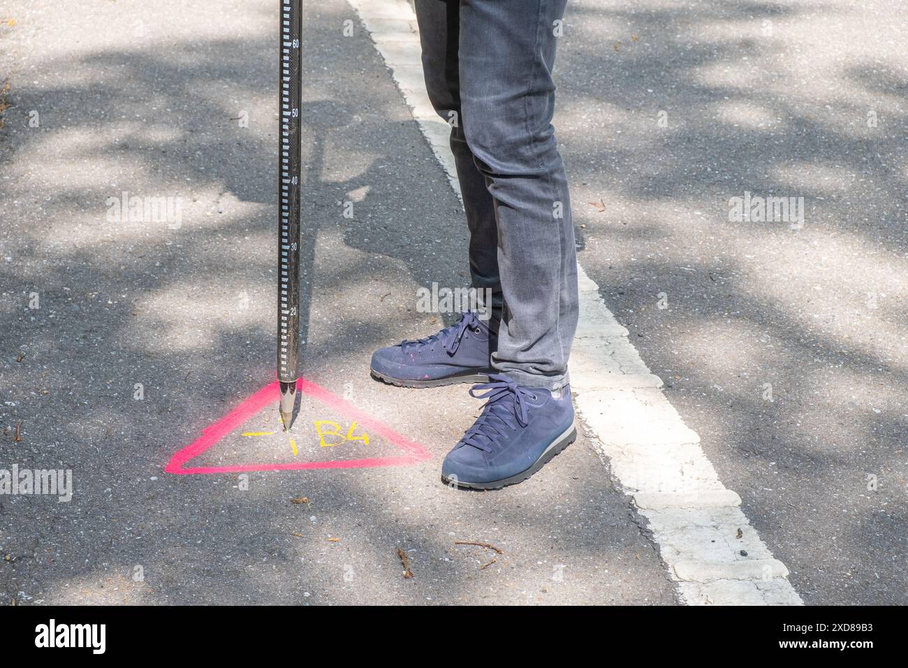 a surveyor holding a gps antenna, measuring the coordinates of a ...