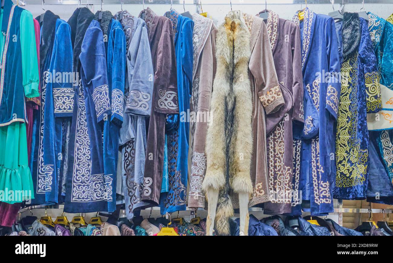 Male national Kazakh robes, velvet with embroidery and fur, on hangers ...
