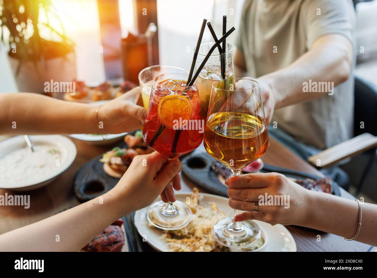 Hands toasting with cocktails hi-res stock photography and images - Alamy