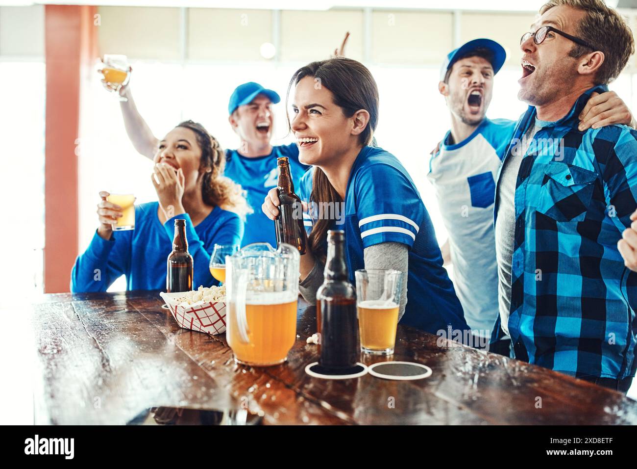 Sports, celebration and people in pub with team solidarity, tv and fans ...