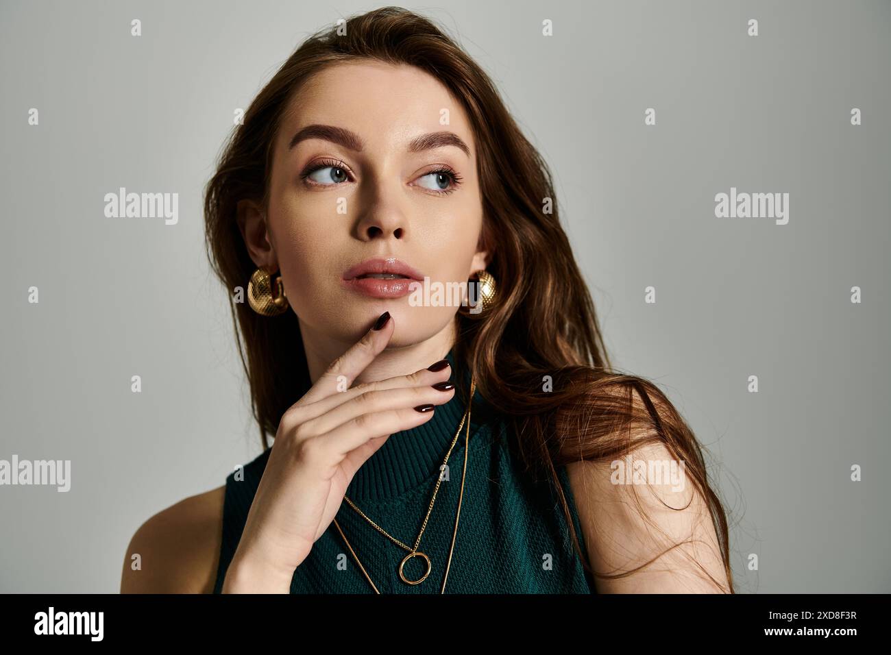 A young woman, clad in a vibrant green top, strikes a pose for a ...