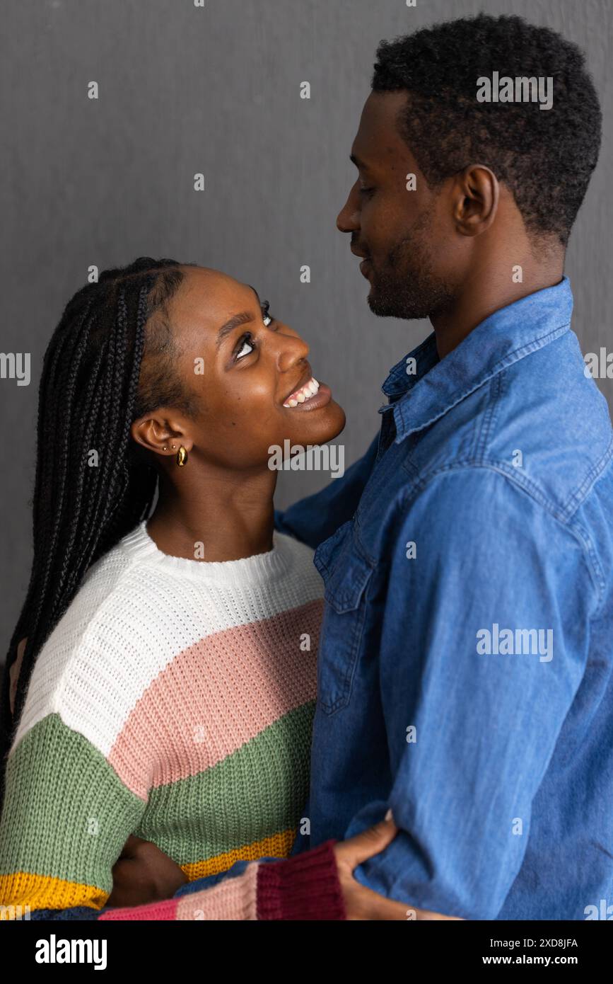 Young African American couple hugging, smiling, and looking into each ...