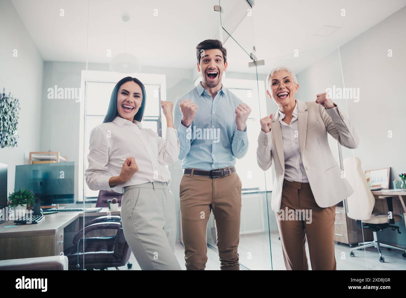 Photo of business people celebrate winning work achievements in office ...