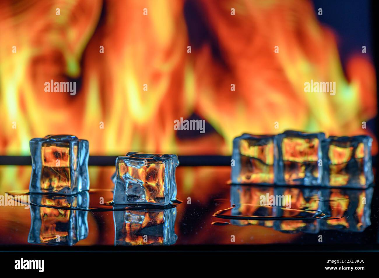cubes of ice and fire on a water surface on an abstract background 2 ...
