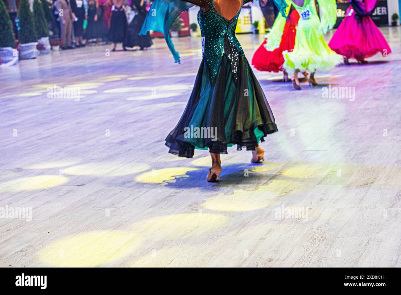 dance on high heels, dance in a lush crowd in multi-colored dresses ...