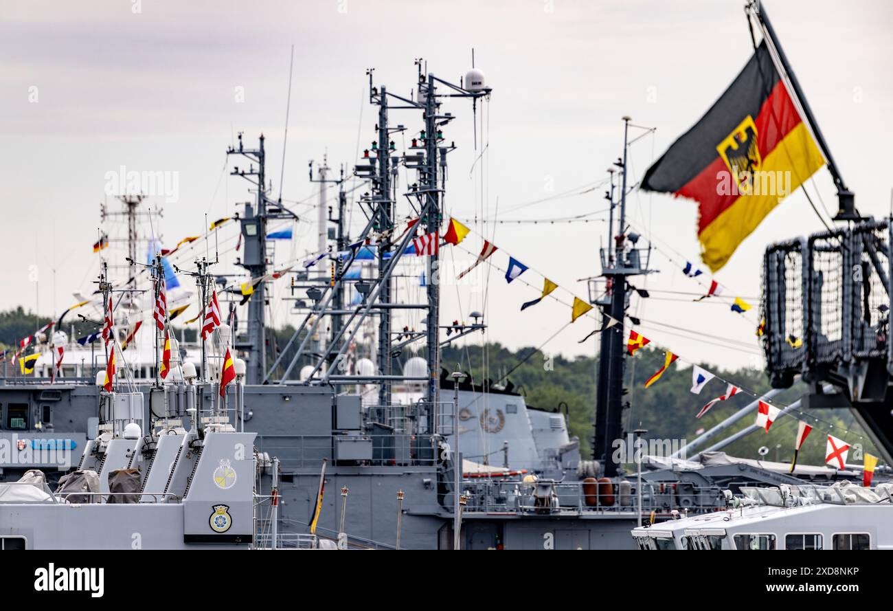 Kiel, Germany. 21st June, 2024. Naval vessels are decorated with flags ...