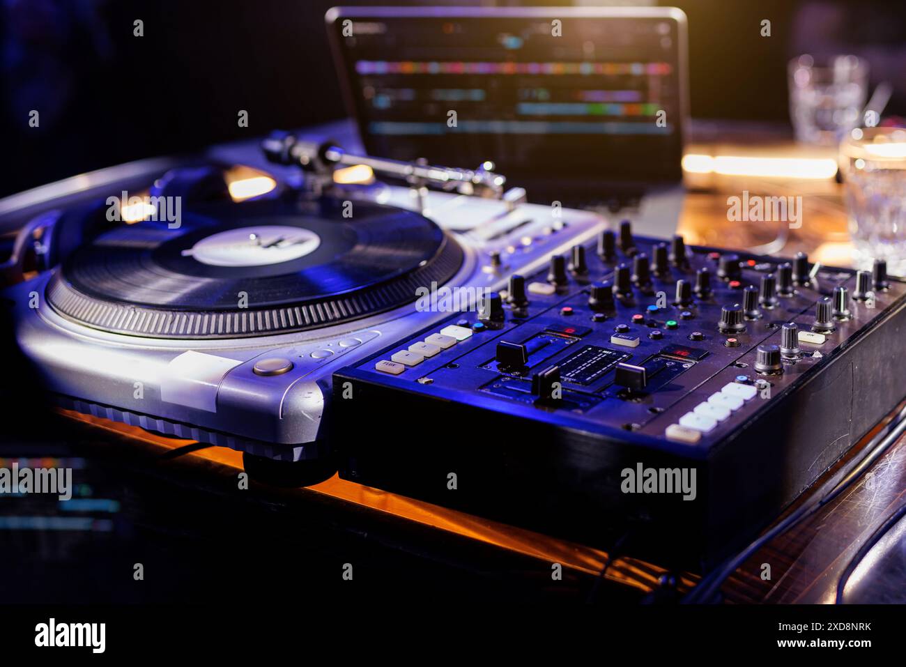 A close-up view of a professional DJ mixing console with various knobs ...