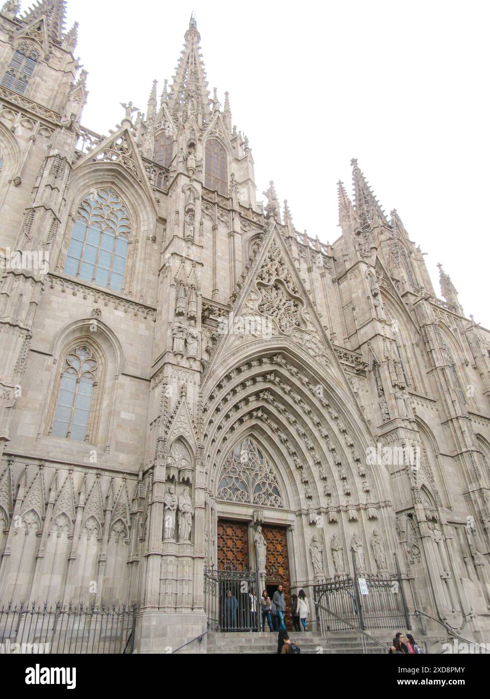Gothic facade of the Barcelona Cathedral with intricate stone carvings ...