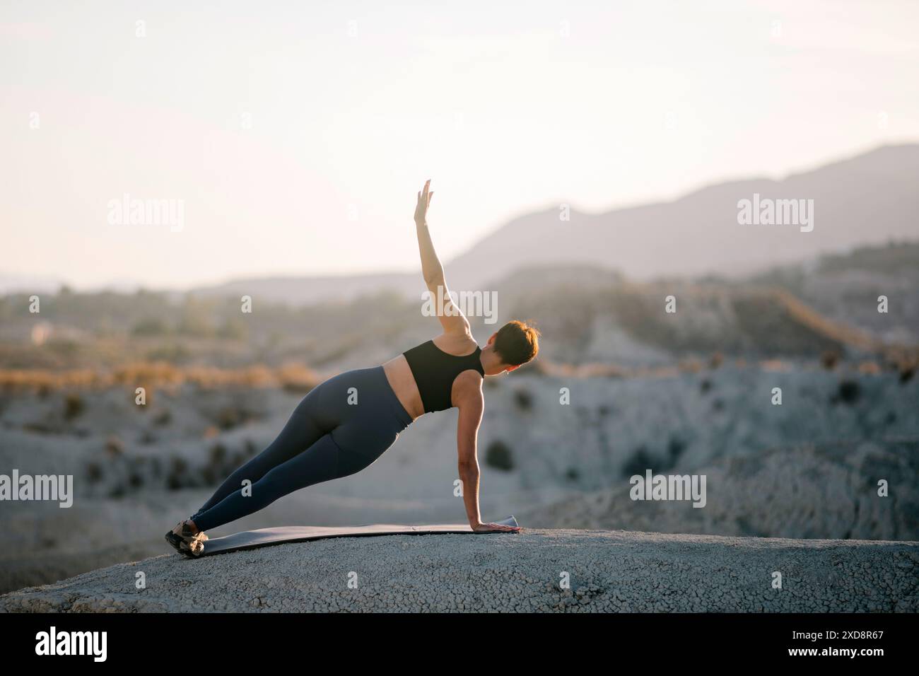 Sporty woman doing asana poses in the desert Stock Photo - Alamy
