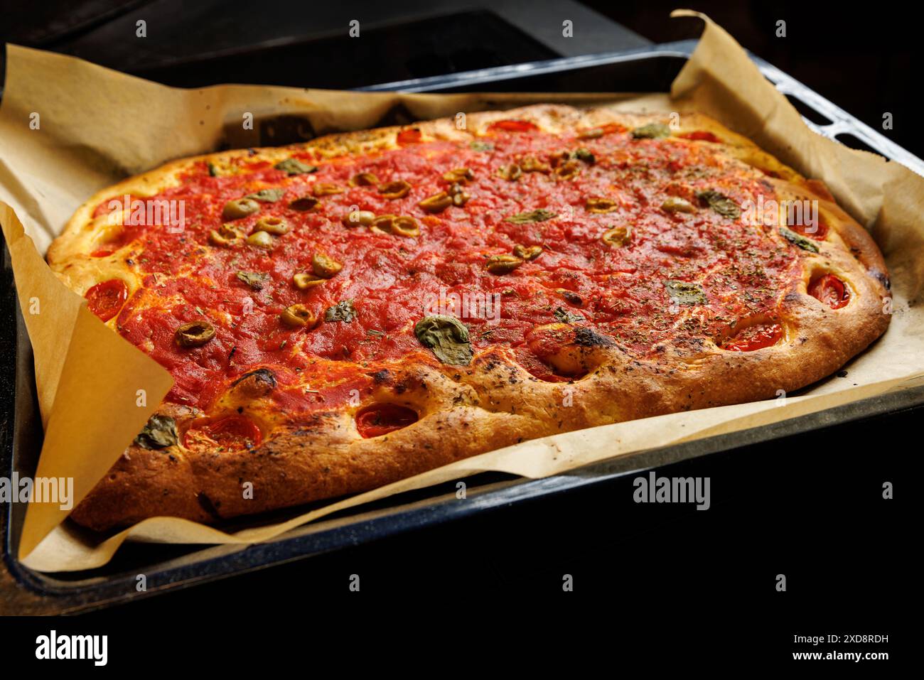 Cooking a homemade focaccia with classic tomato sauce Stock Photo - Alamy