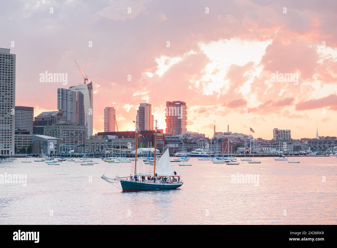 Sailboat in harbor with Boston skyline at sunset and vibrant sky Stock ...