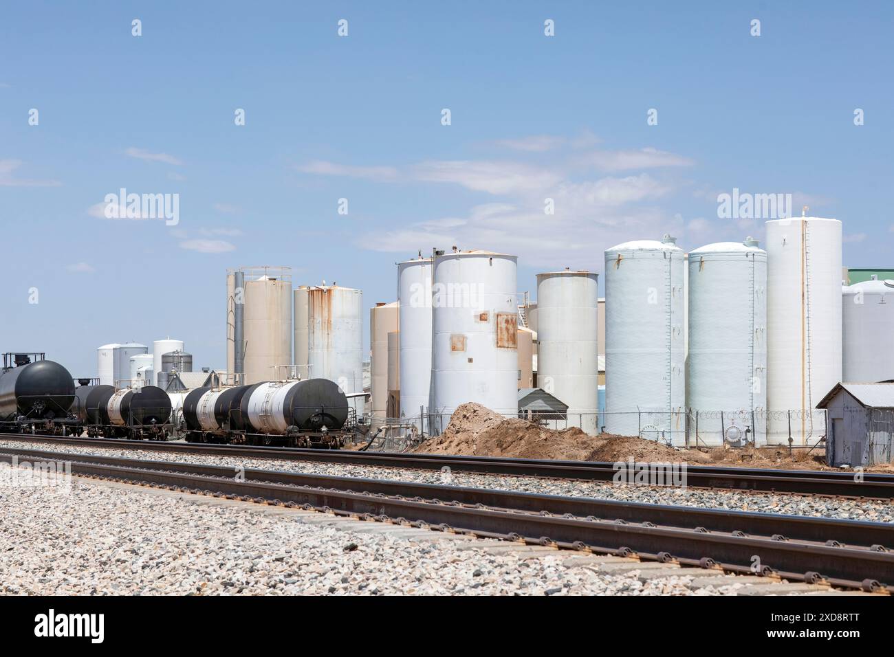 Chemical storage tanks along railroad tracks Stock Photo - Alamy