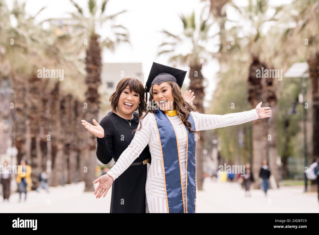 Excited mother and graduate daughter on graduation day with palm Stock ...