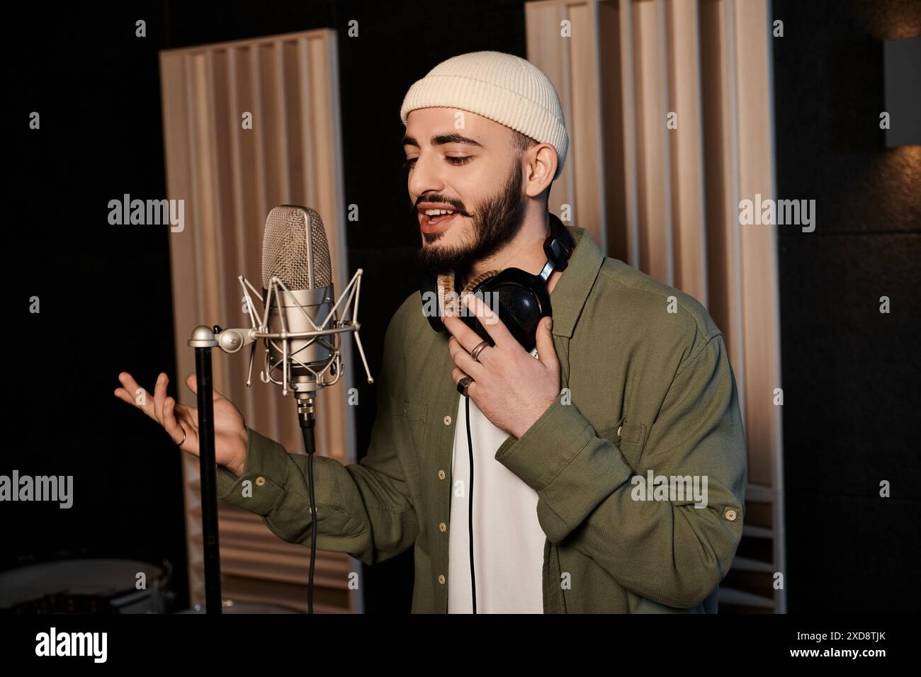 A male artist passionately sings into a microphone, capturing the ...