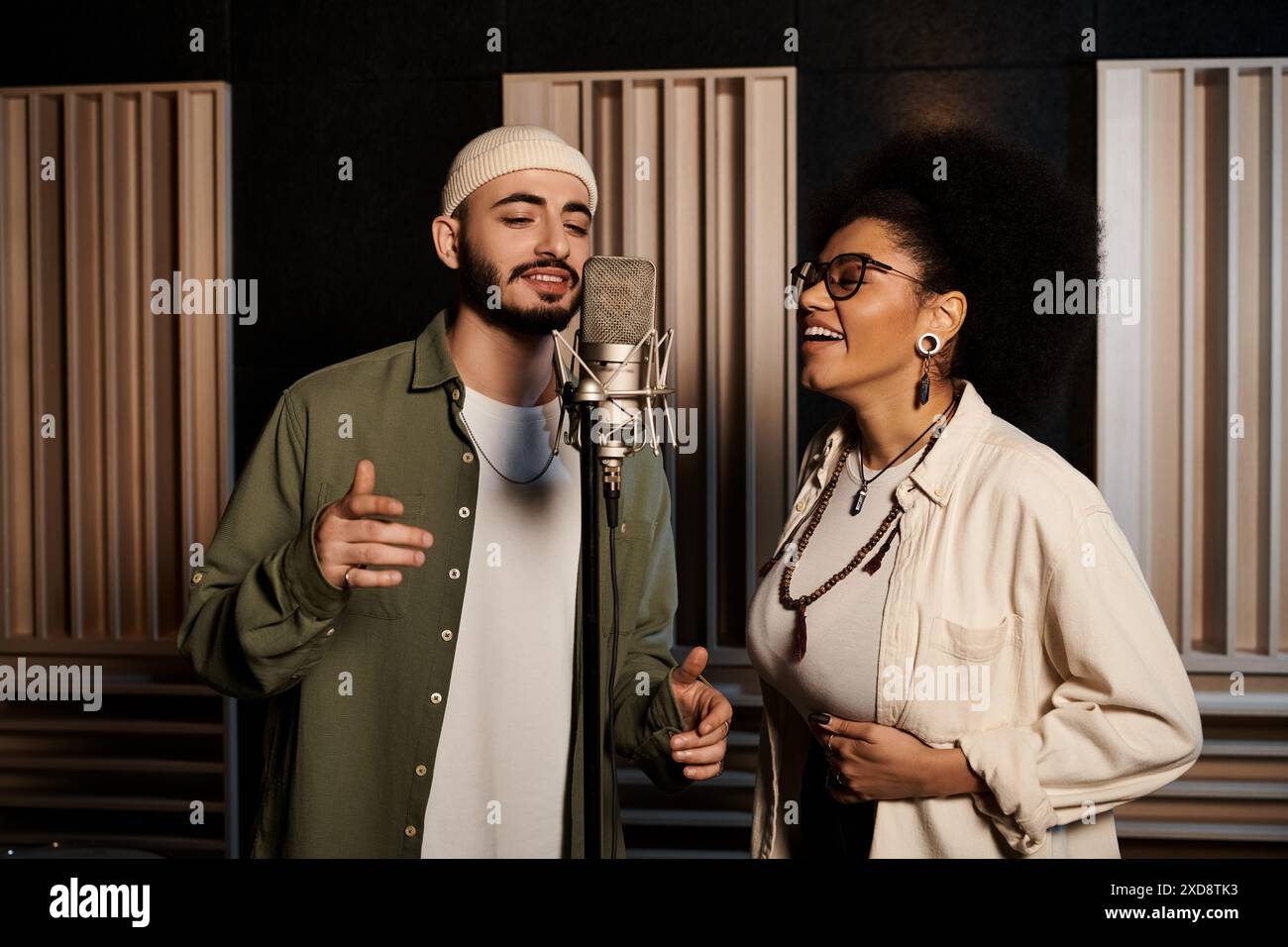 A man and woman passionately sing together in a recording studio ...
