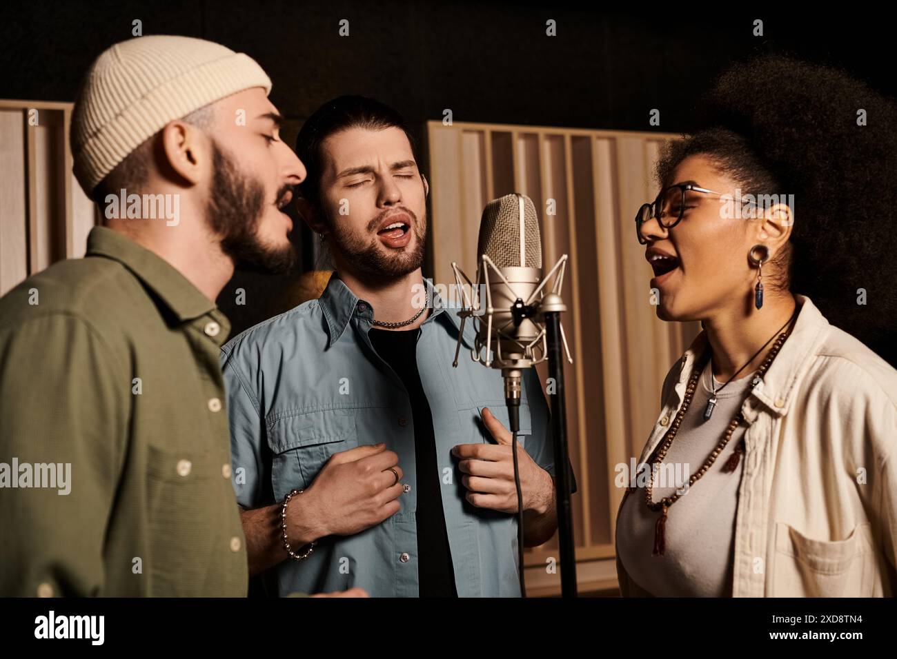 Three individuals passionately singing into a microphone while ...