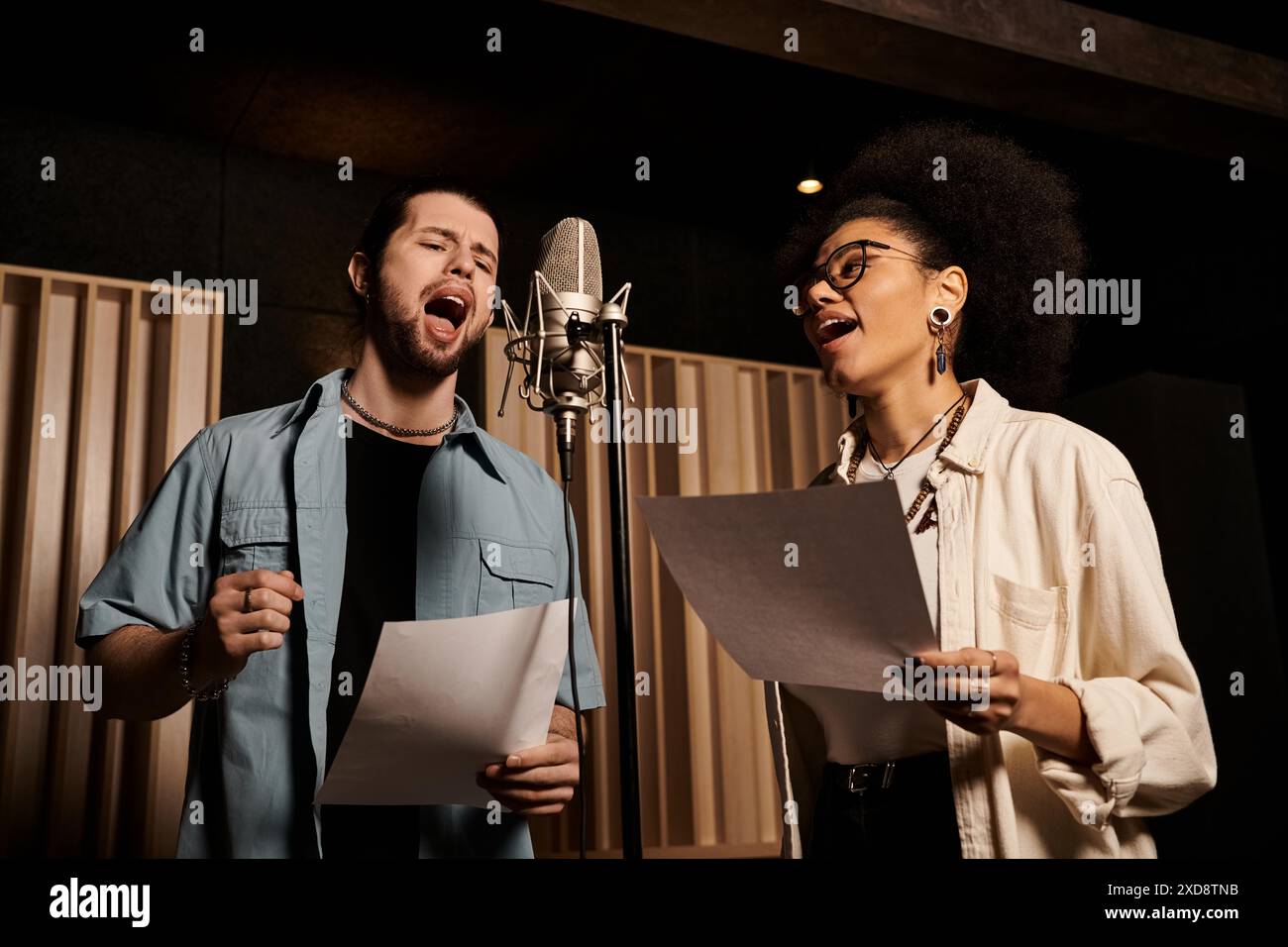 Two singers share a microphone, harmonizing in a music studio during ...