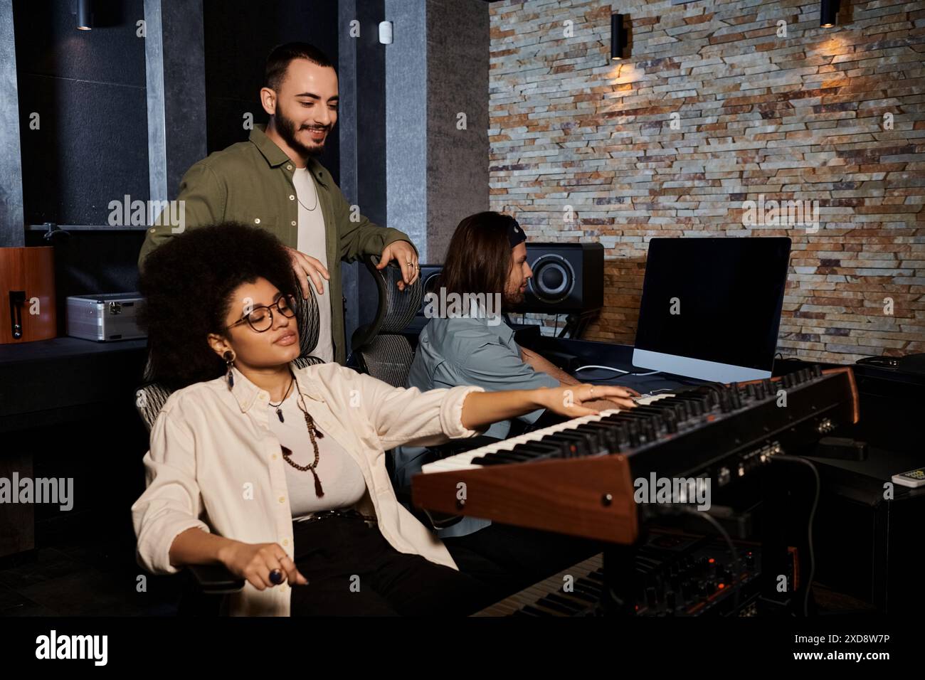 A diverse group of individuals collaborate in a recording studio ...