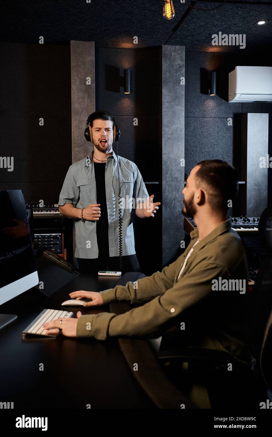 Two men in a recording studio engage in animated discussion during a ...