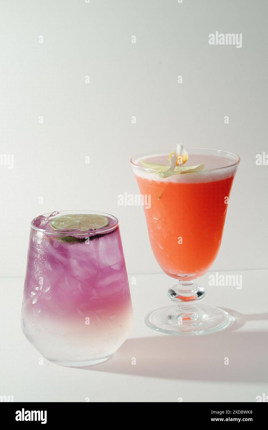 Two vibrant cocktails, one purple, one orange Stock Photo - Alamy