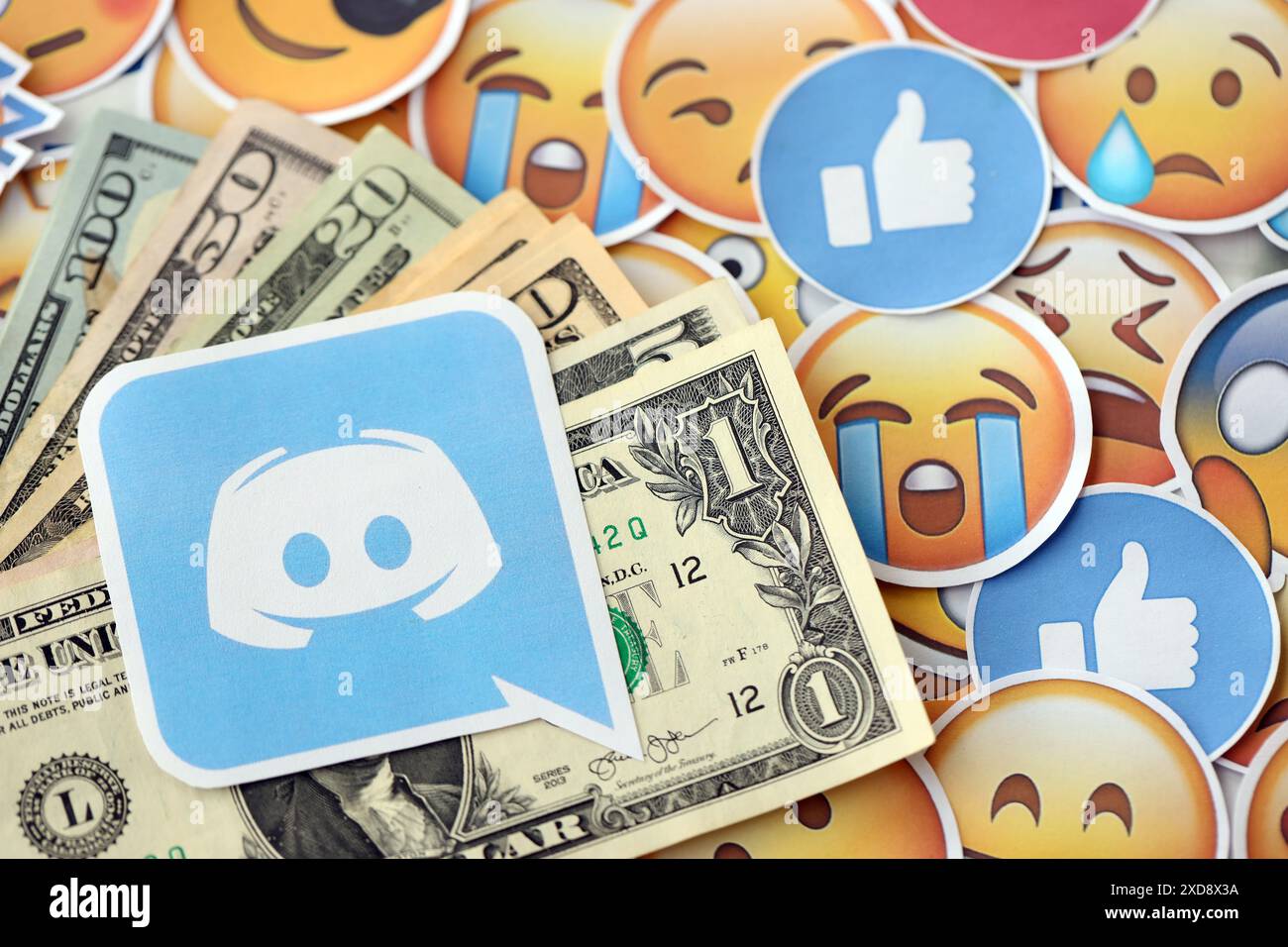 KYIV, UKRAINE - APRIL 20, 2024 Discord logo and many usd money bills ...