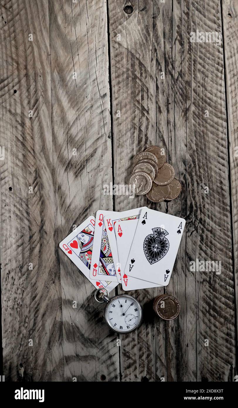 A poker hand playing cards, ace of spades on top, with pocket watch and ...