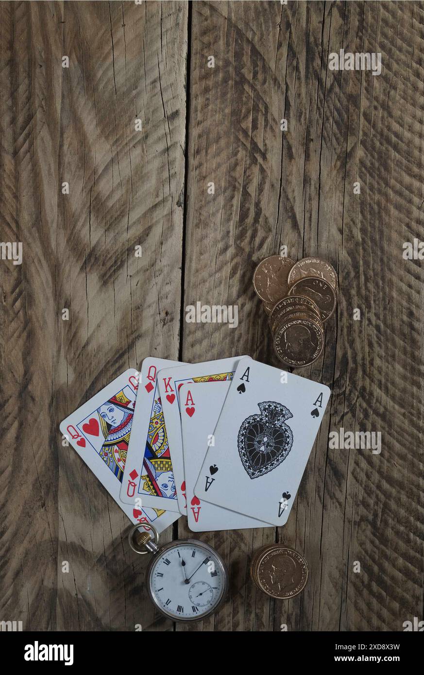 A poker hand playing cards, ace of spades on top, with pocket watch and ...