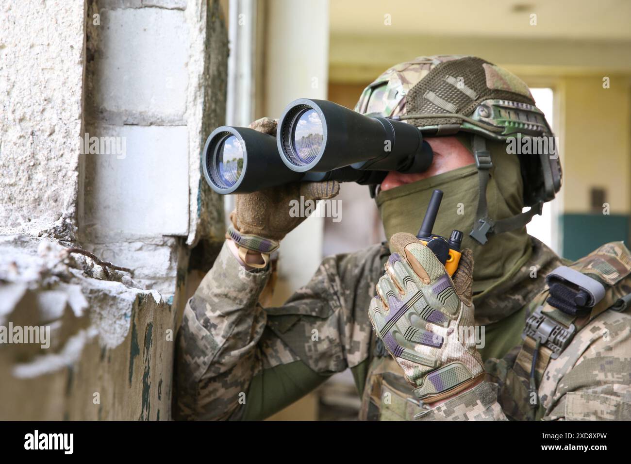 Military mission. Soldier in uniform with binoculars inside abandoned ...
