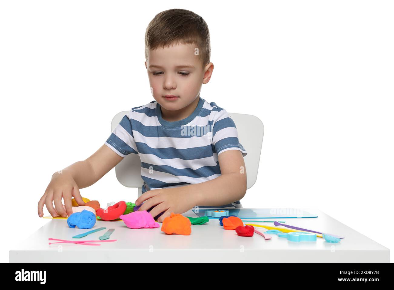 Little boy sculpting with play dough at table on white background Stock ...