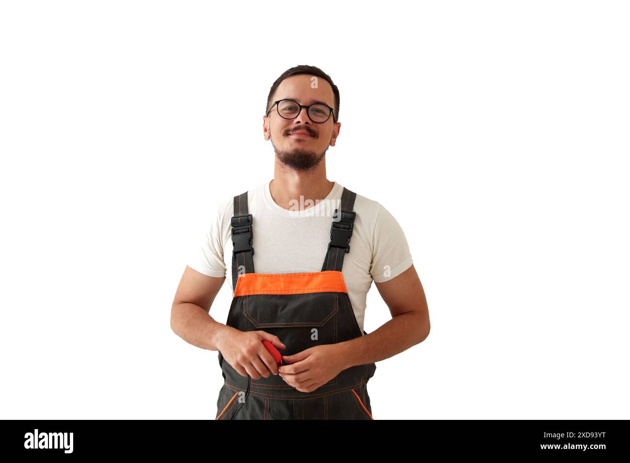 Portrait of young happy handyman presenting something isolated on white ...
