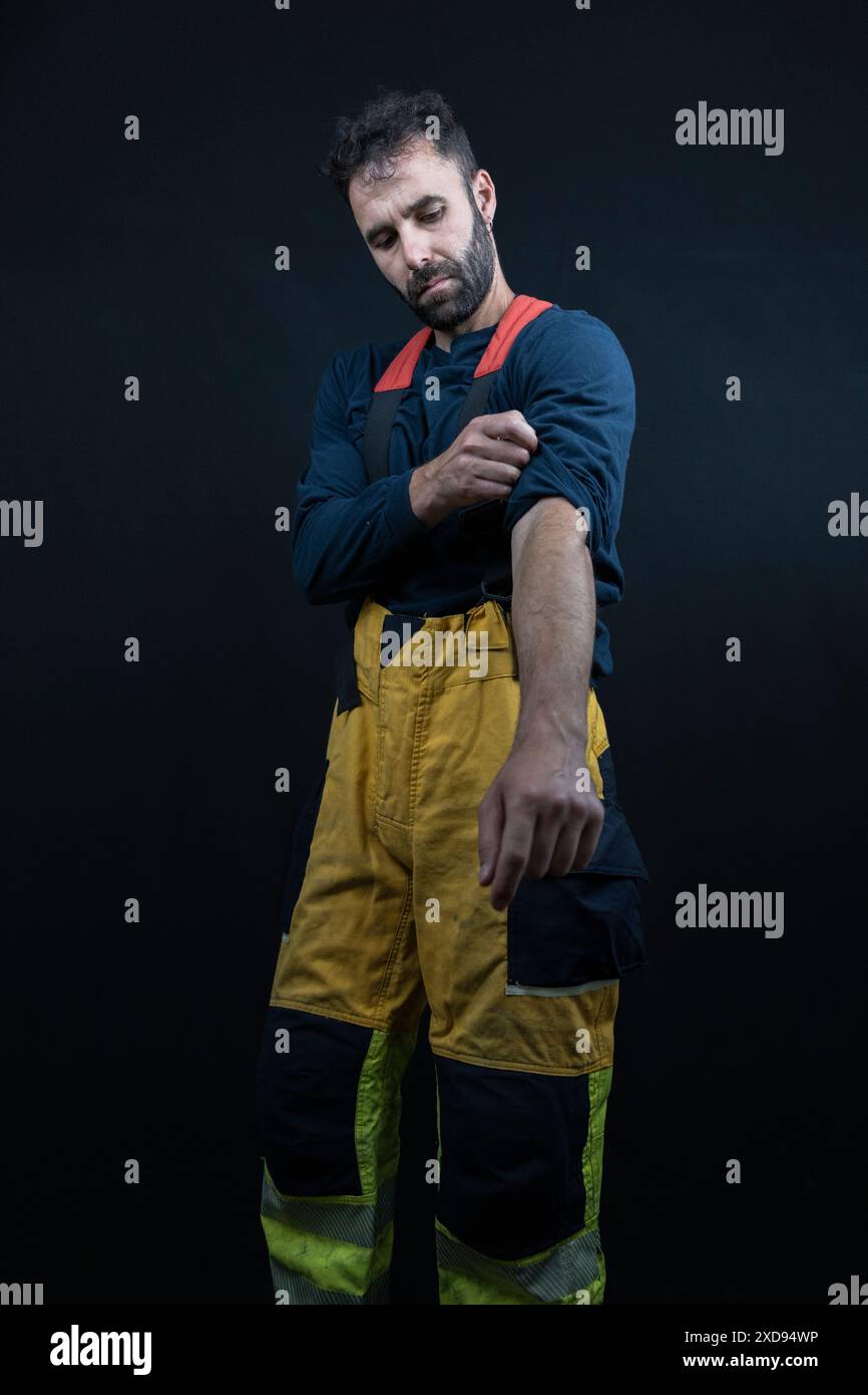 Firefighter dressing up in a photo studio Stock Photo - Alamy