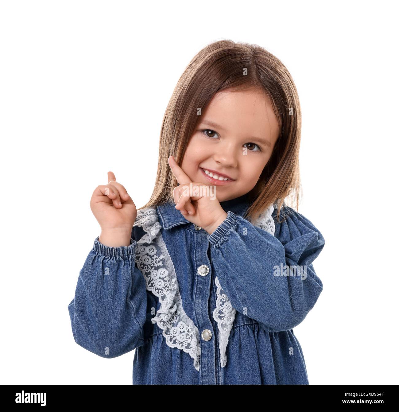Portrait of happy little girl pointing at something on white background ...