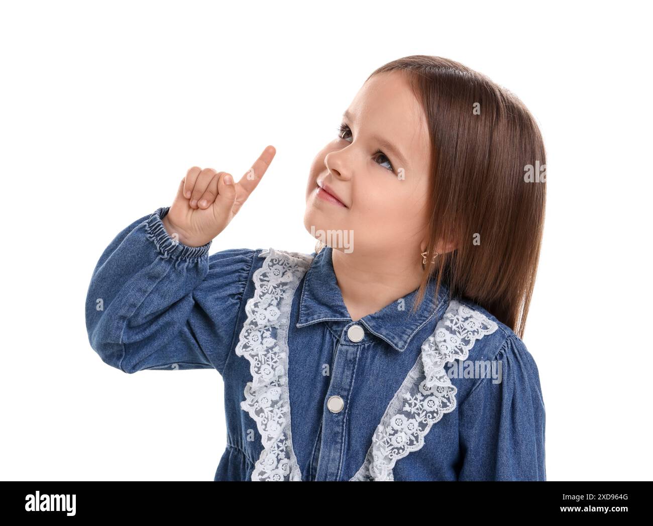 Portrait of cute little girl pointing at something on white background ...