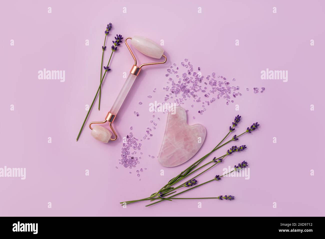 Roller quartz massager, gua sha, bath salt scattering, sprigs of fresh ...