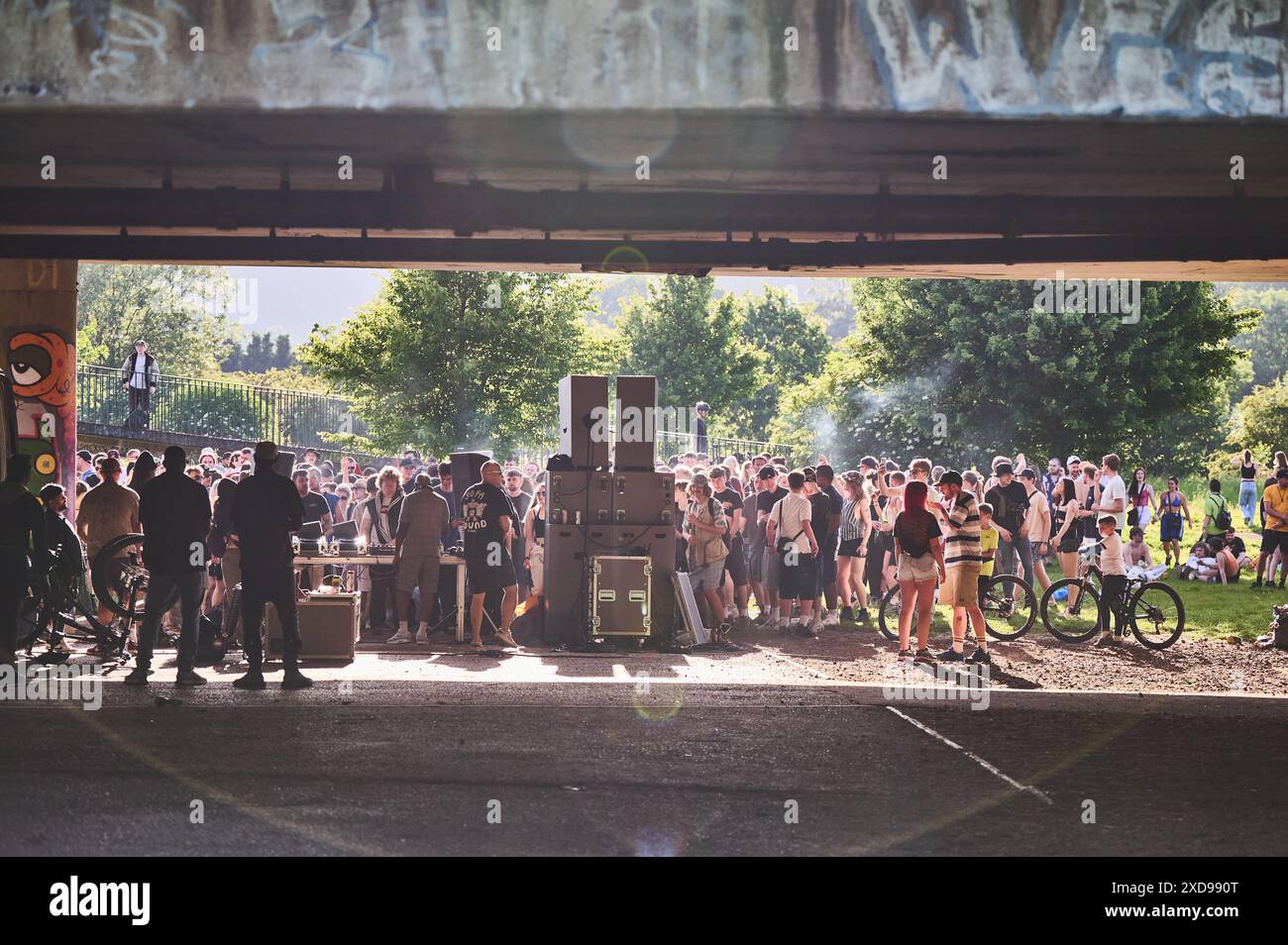 Rave under a bridge in the summer with large soundsystem and speakers ...
