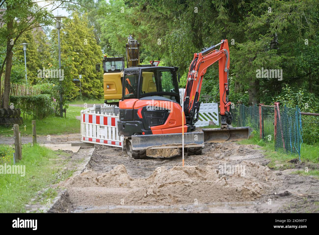 Construction vehicles with caterpillar and excavator working on a ...
