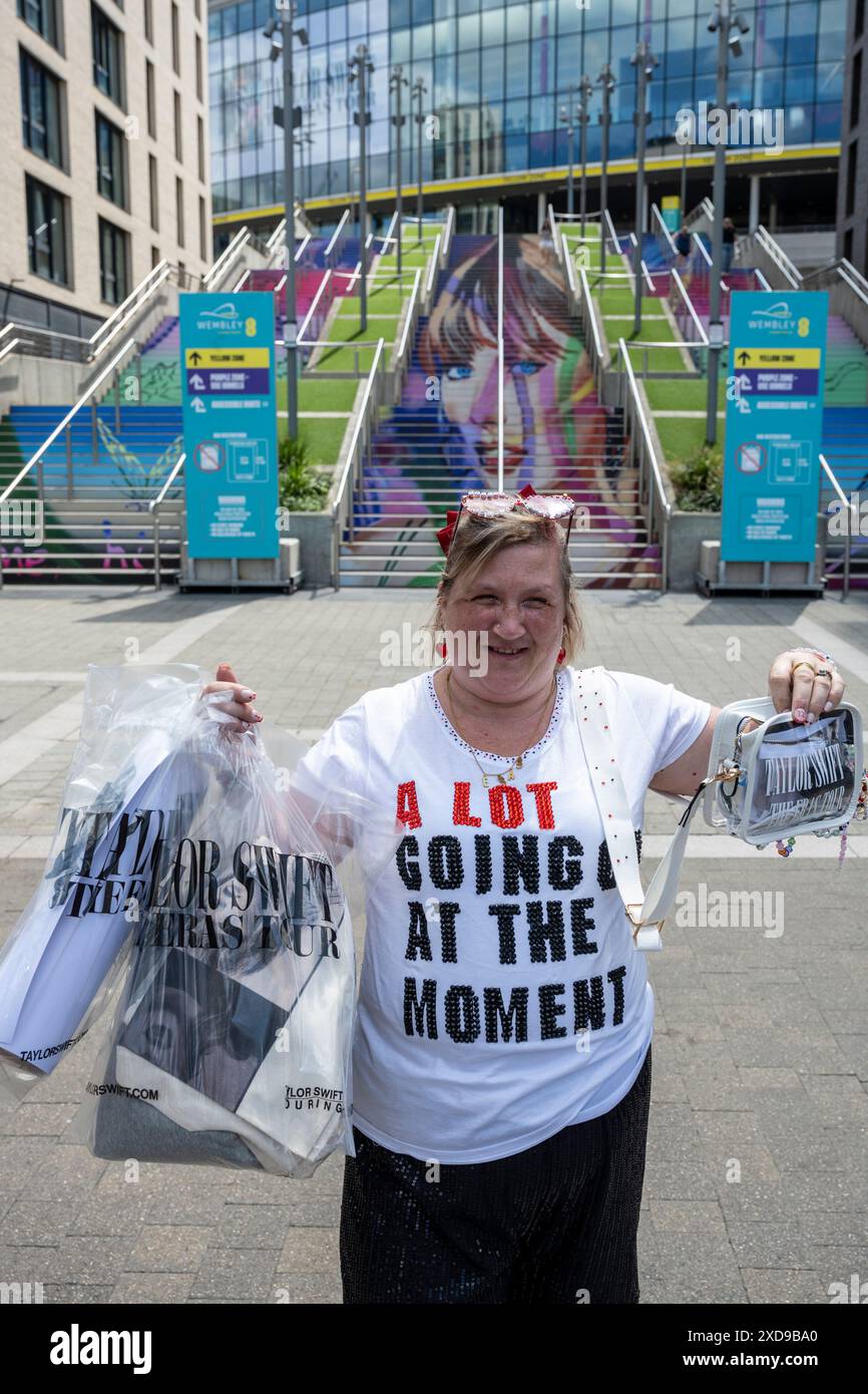 London, UK. 21 June 2024. A Swiftie fan wears a tour T shirt by the new ...