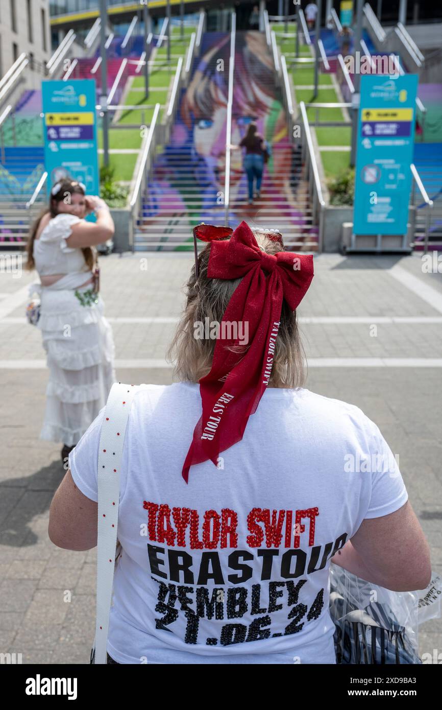 London, UK. 21 June 2024. A Swiftie fan wears a tour T shirt by the new ...