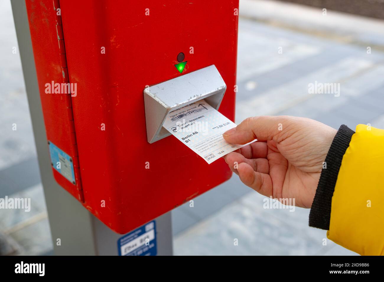 traveler validating train ticket at terminal, public transportation ...