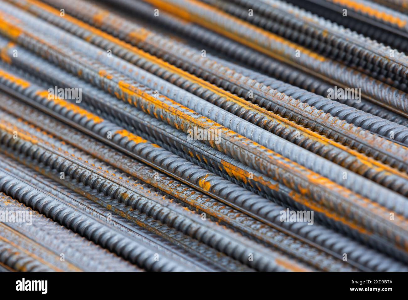 Stacked construction iron rods with rust spots, abstract industrial ...