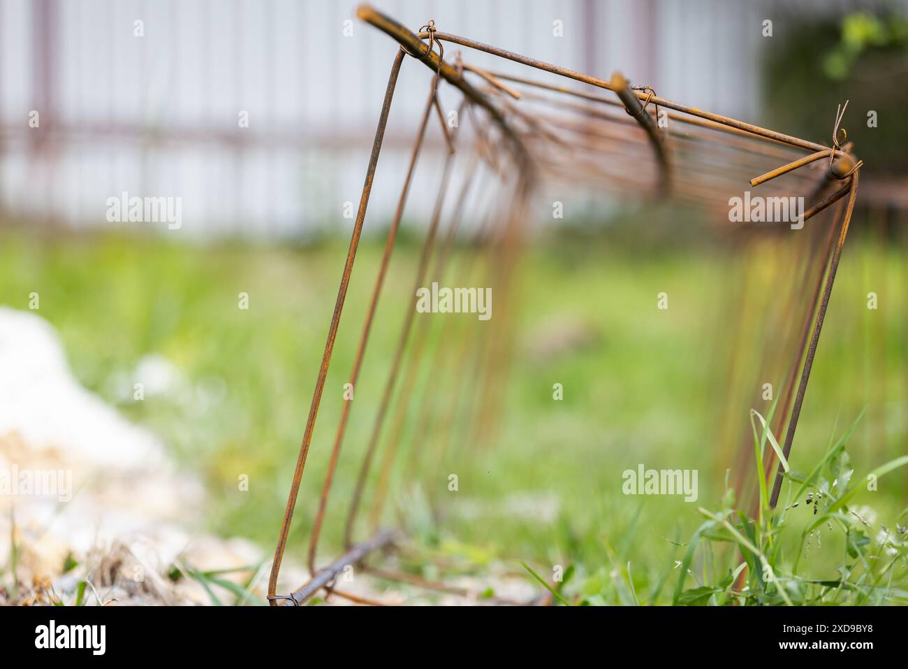 Reinforcement cage lay on green grass at construction site, abstract ...