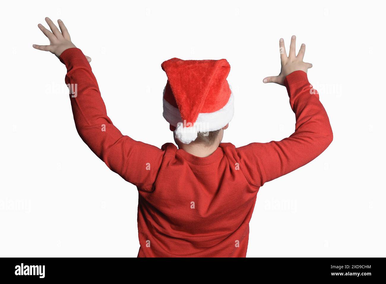 A boy in a Santa suit with his back to the camera. Wave your arms like ...
