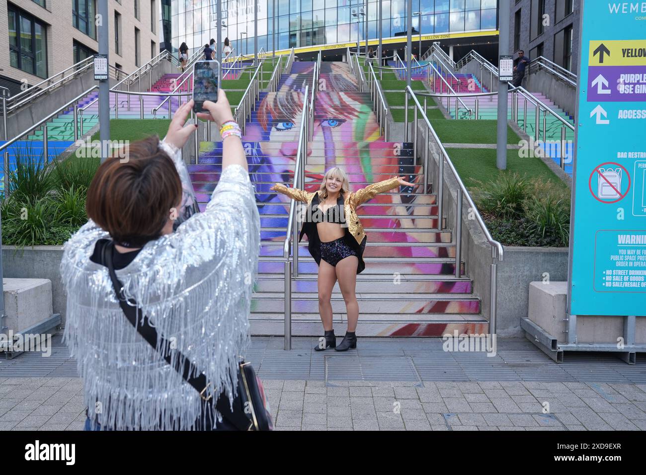 Fans wait outside Wembley Stadium in London, ahead of Taylor Swift's ...